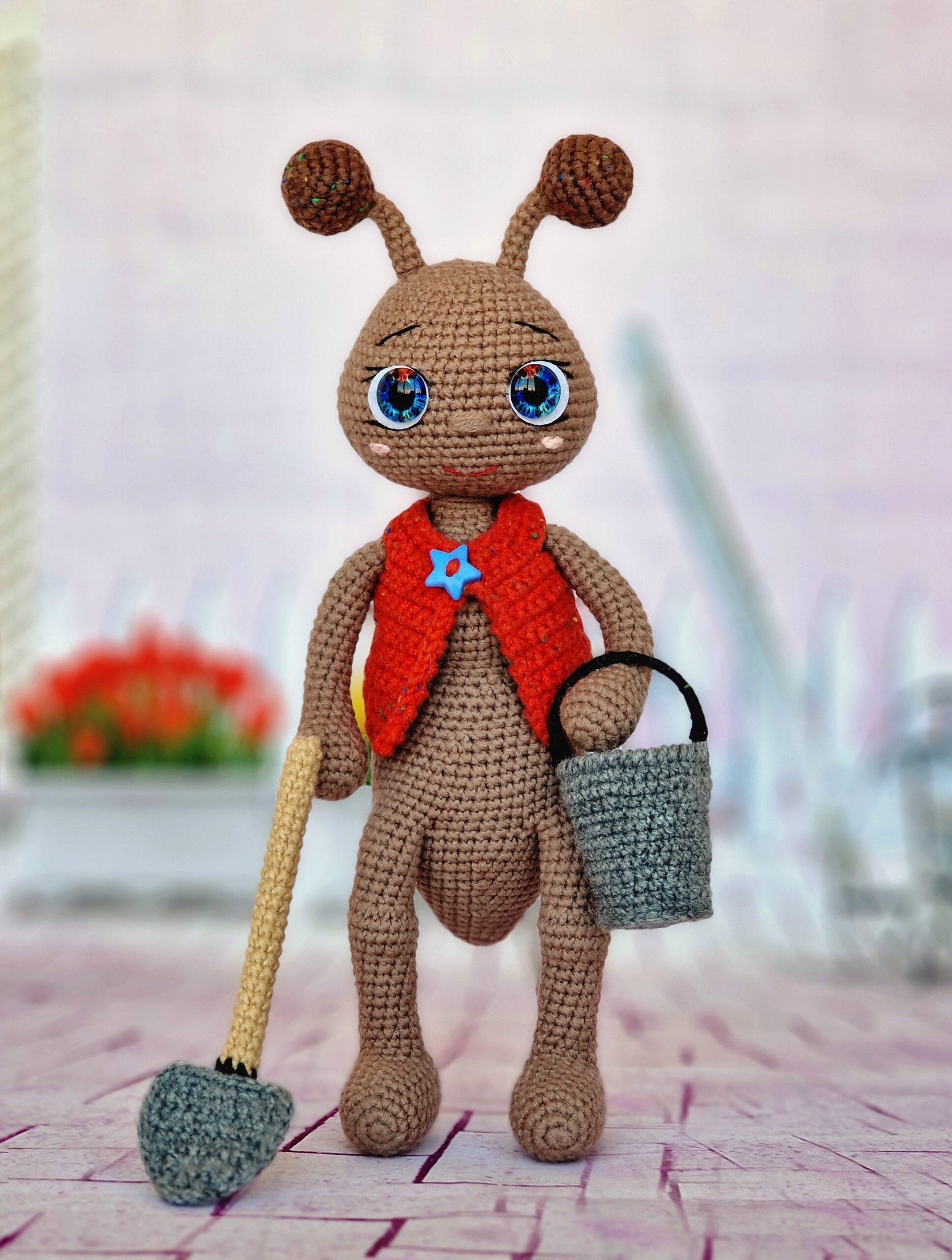 Cute funny soft toy industrious ant with a bucket and shovel