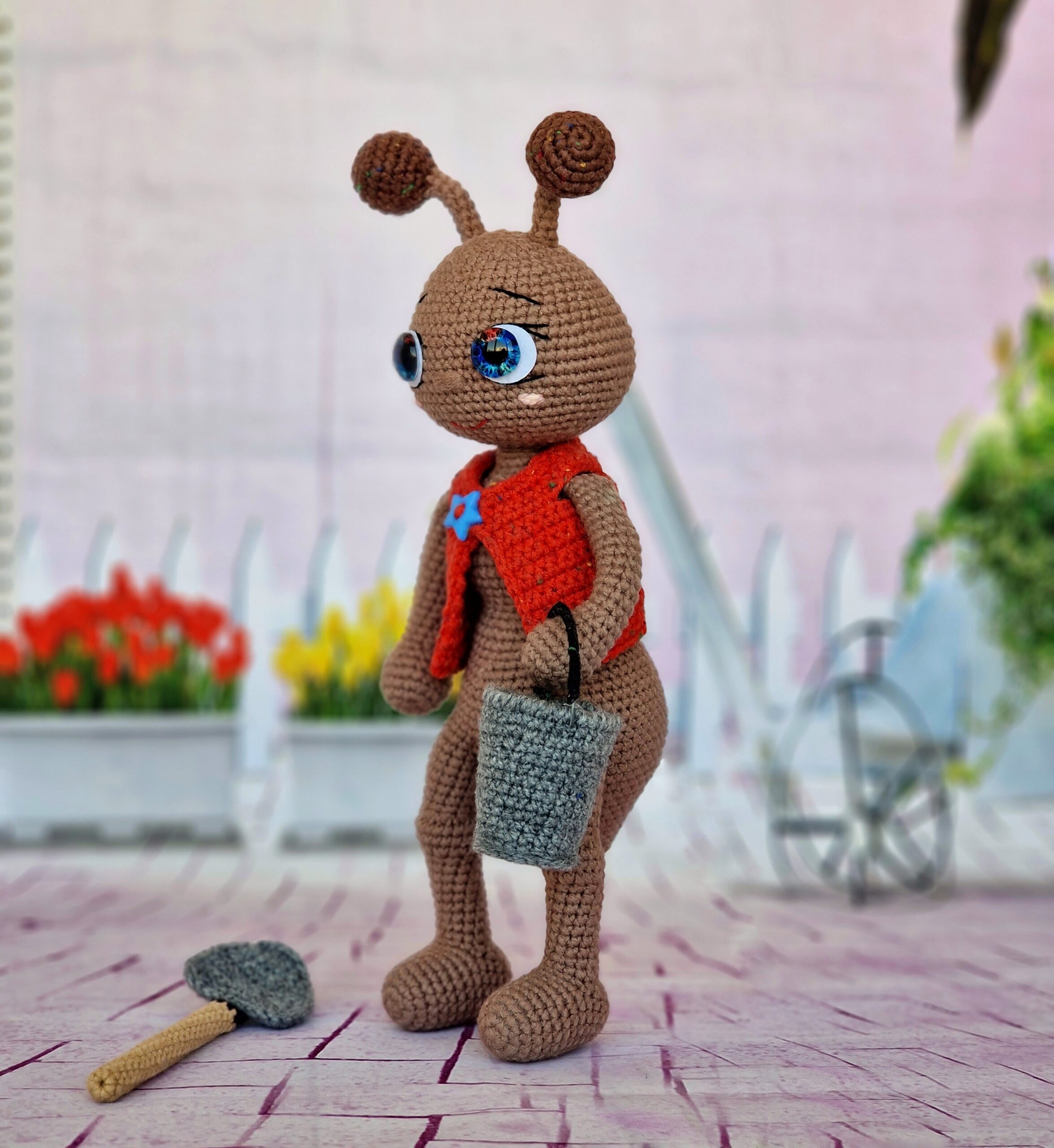 Cute funny soft toy industrious ant with a bucket and shovel