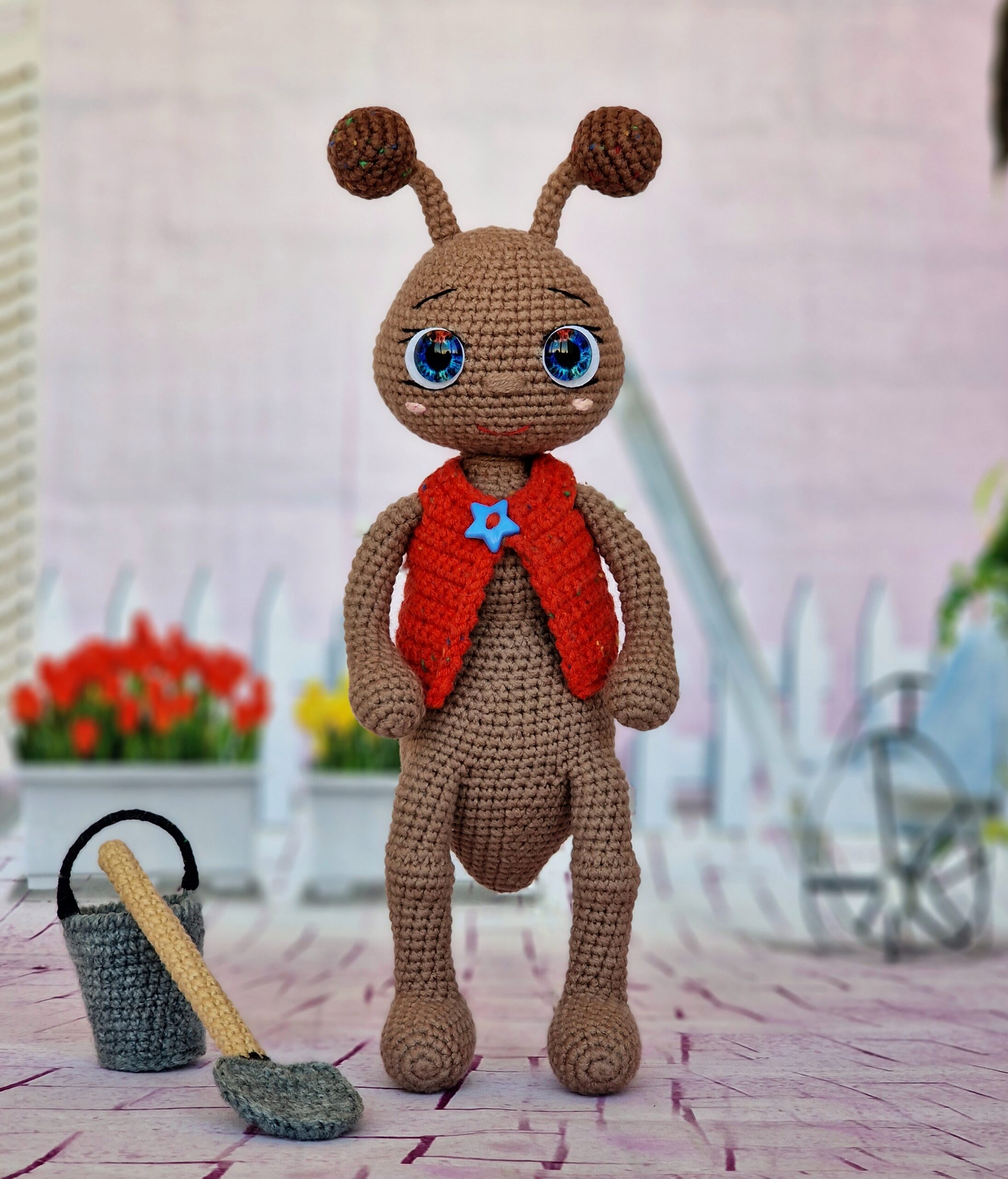 Cute funny soft toy industrious ant with a bucket and shovel
