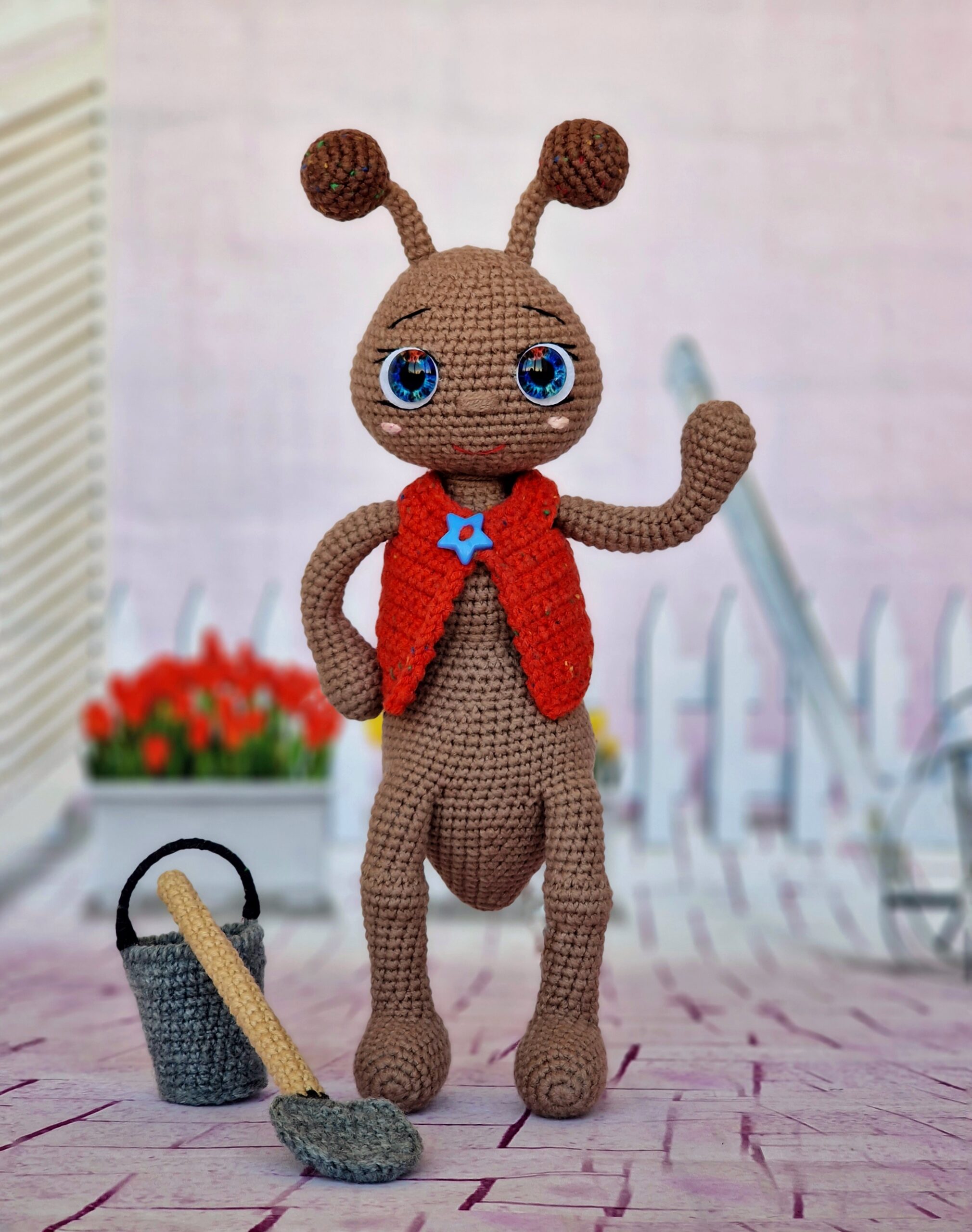 Cute funny soft toy industrious ant with a bucket and shovel